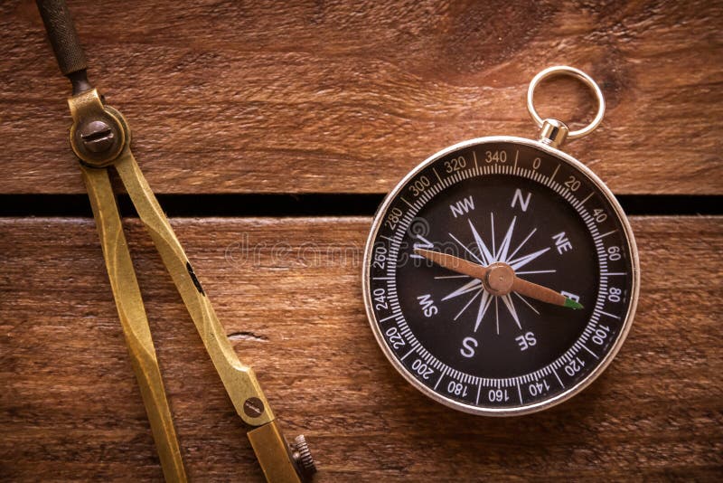 Vintage Drawing and Navigational Compass on a Rustic Board Stock Image ...
