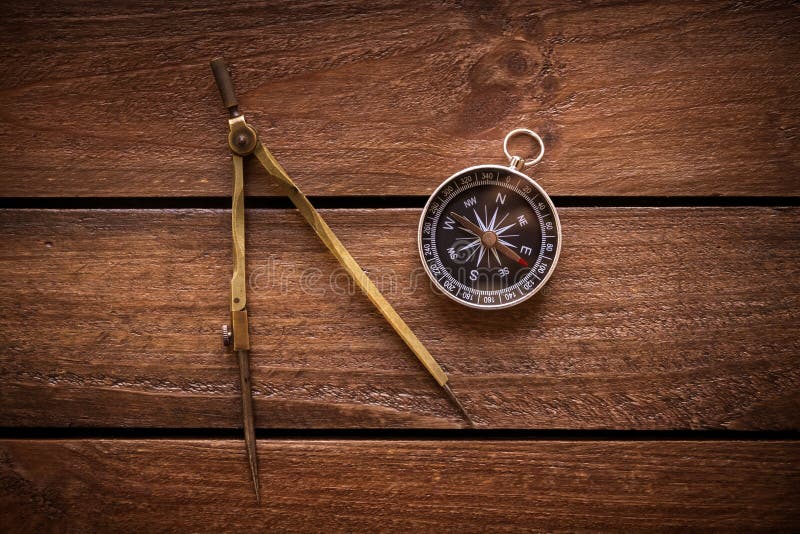 Vintage Drawing and Navigational Compass on a Rustic Wood Board Stock ...