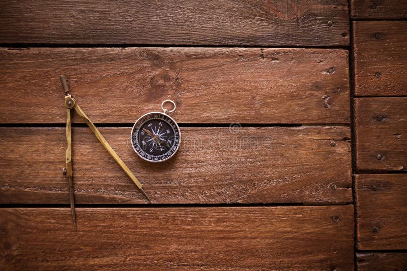 Vintage Drawing and Navigational Compass on a Rustic Wood Board Stock ...