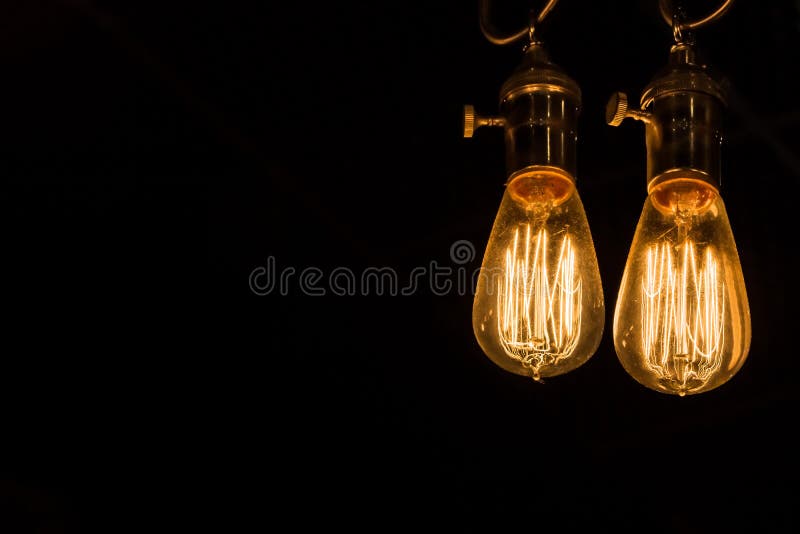 Vintage Edison Light Bulbs Hanging Against a Black Background Stock ...