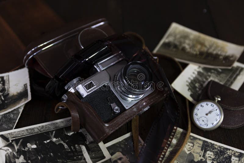 Vintage Film Camera and Old Photographs on a Rustic Surface Editorial ...