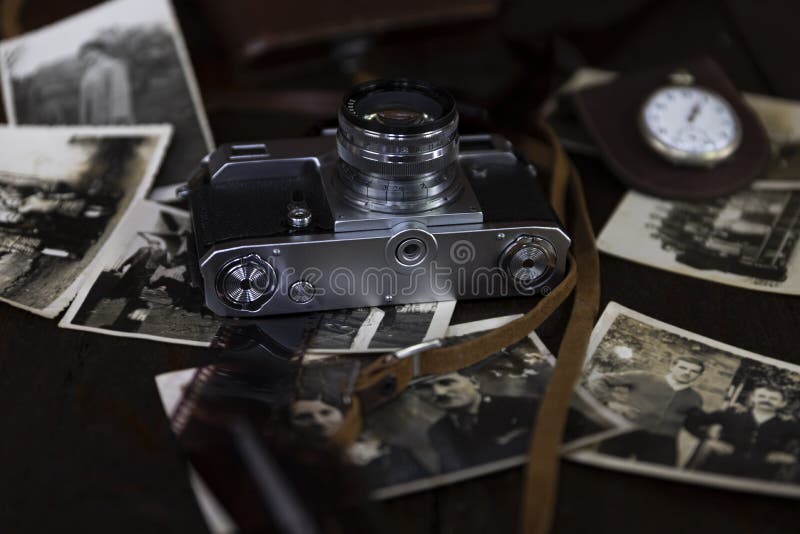 Vintage Film Camera and Old Photographs on a Rustic Surface Editorial ...