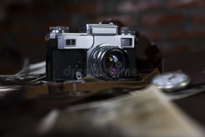Vintage Film Camera and Old Photographs on a Rustic Surface Stock Photo ...