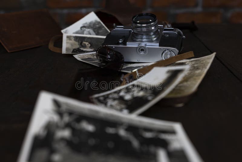 Vintage Film Camera and Old Photographs on a Rustic Surface Editorial ...