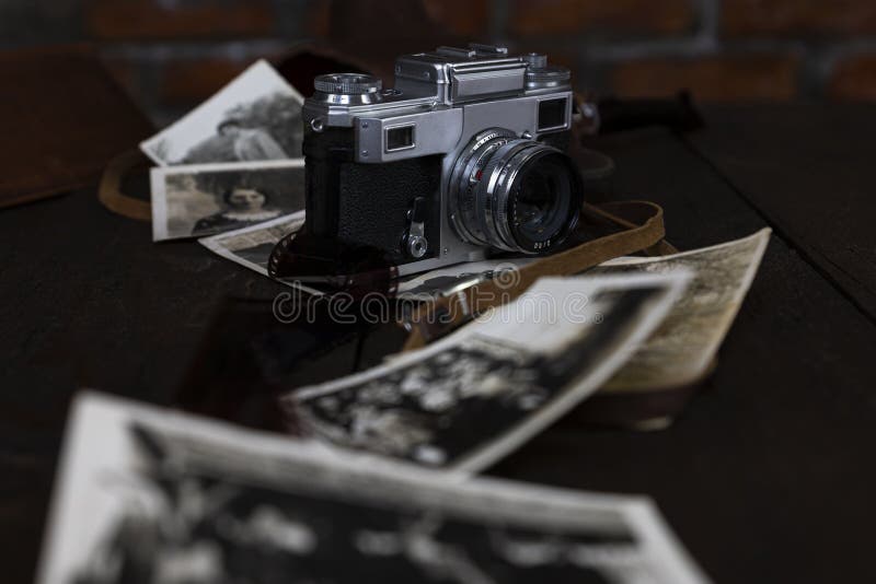 Vintage Film Camera and Old Photographs on a Rustic Surface Editorial ...