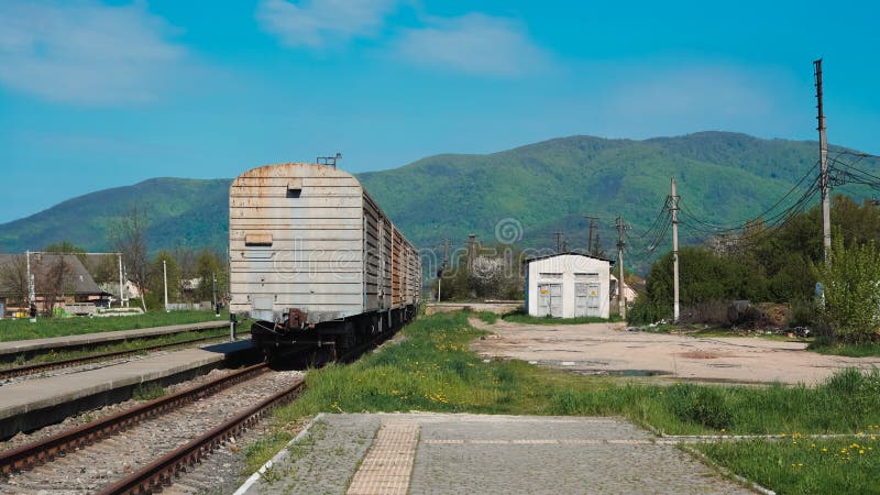 Old Freight Train at the Station with Mountain Background in Sunlight ...