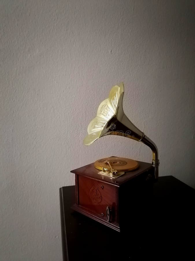 Vintage Gramophone Music Box on a Wooden Table with Dramatic Lighting ...