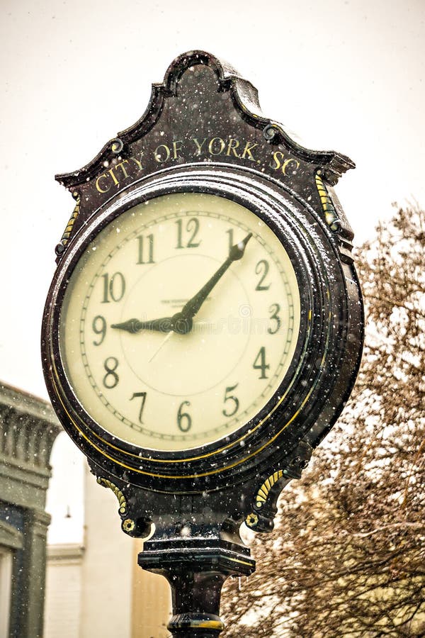 Vintage Historic Street Clock with Snow Falling in Winter Stock Image ...