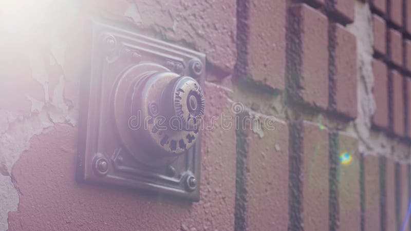 Weathered Vintage Intercom Mounted on Cracked Brick Surface, Displaying Communication Technology ...