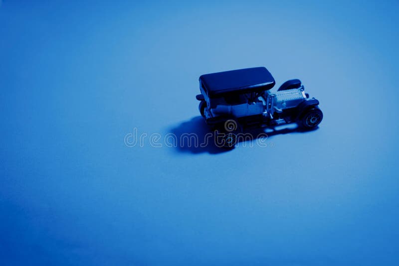 Vintage Jeep Toy Car with a Shadow on a Table Under Blue Light Stock ...
