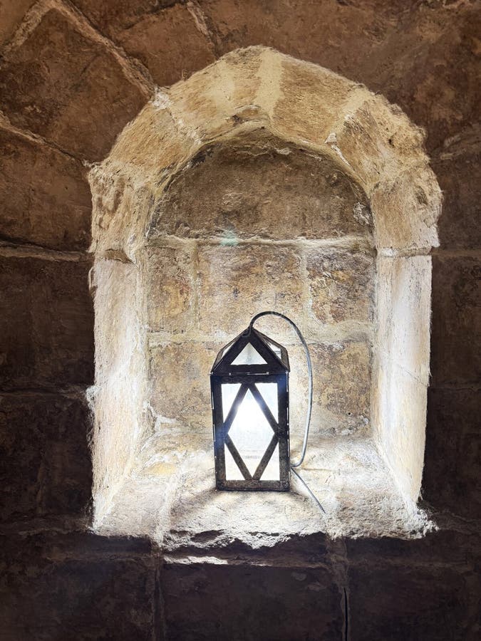 Vintage Lantern Glowing in Arched Stone Niche with Textured Medieval ...