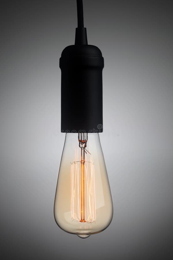 Vintage Old Light Bulb Glowing on Rough Dark Background Surrounded by ...