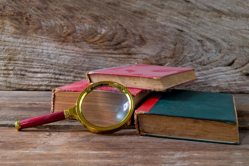 Vintage Magnifying Glass with Old Books. Concept for Learn Stock Photo ...
