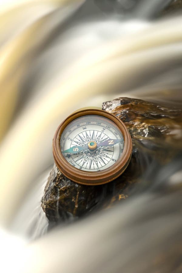 Vintage Navigation Compass in with Water Streaming Around the Device ...