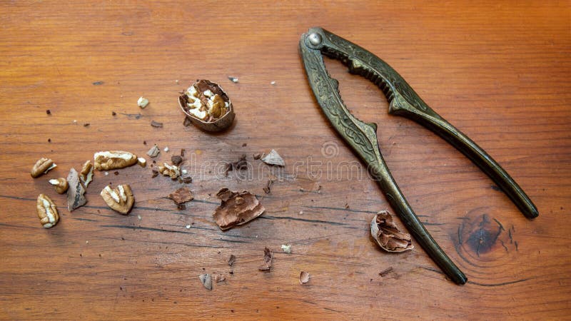 Vintage Nut Cracker with Pecan Nuts on a Wood Table Stock Photo - Image ...