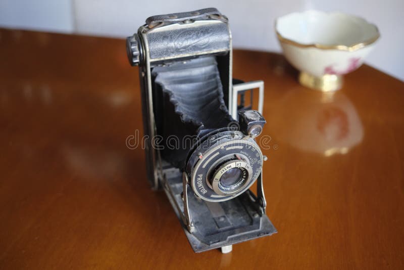 Vintage Old Ancient Camera on a Table Stock Image - Image of strap ...