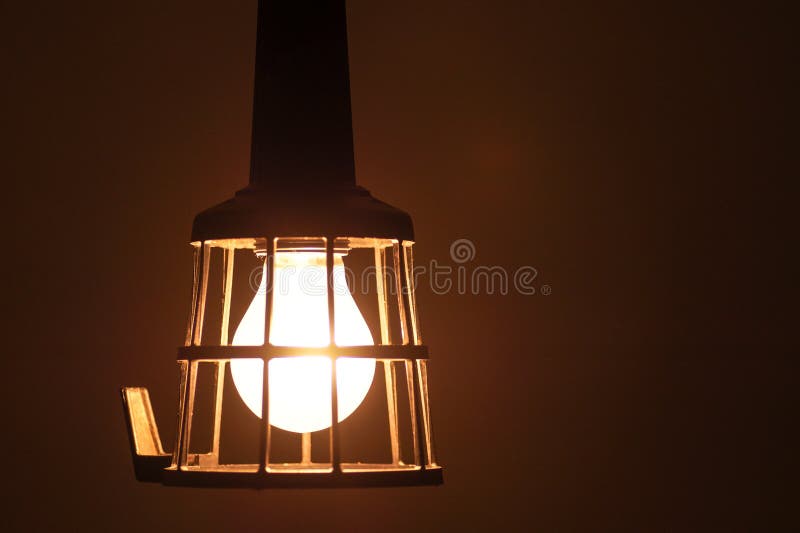 Vintage Old Bulb, Rustic Barn Lamp Light Glows in the Dark Stock Photo ...