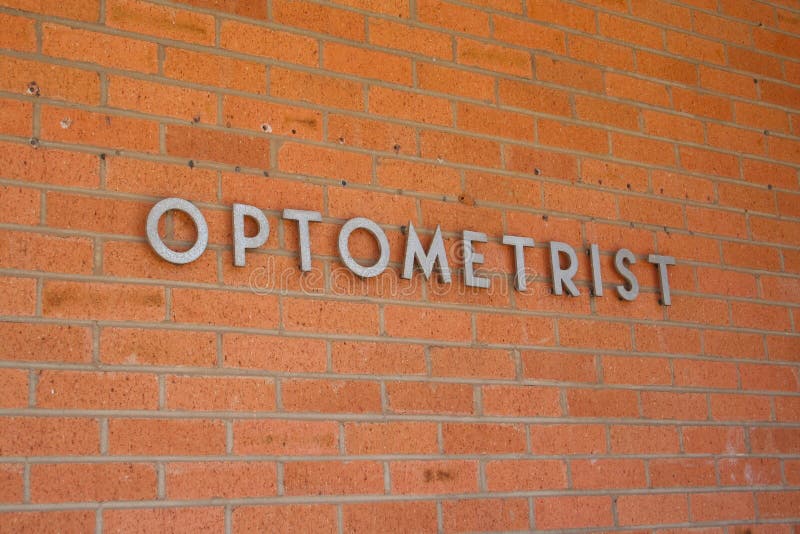 Vintage Optometrist Sign on Red Brick Wall Stock Image - Image of sign ...
