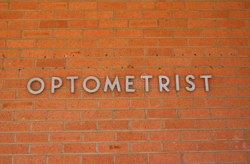 Vintage Optometrist Sign on Red Brick Wall Stock Photo - Image of ...