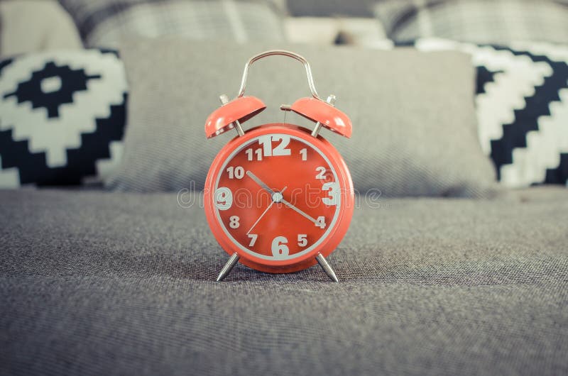 Vintage Photo Style of Red Alarm Clock on Bed Stock Photo - Image of ...