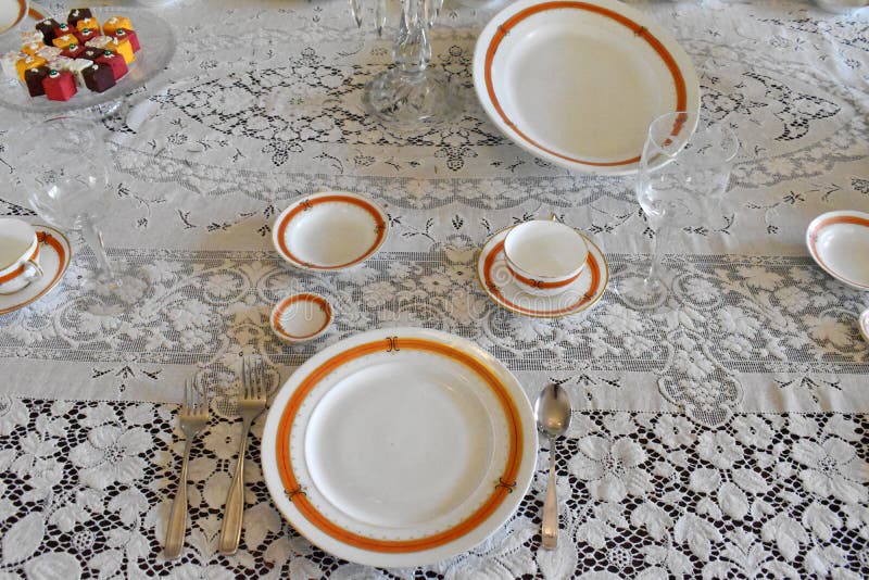 Vintage Place Settings on Laced Tablecloth Stock Photo - Image of ...