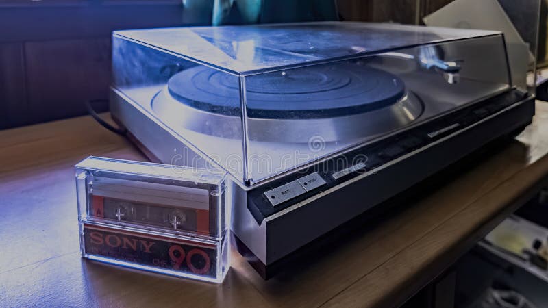 Vintage Record Player Sitting On A Bookshelf In A Basement Editorial