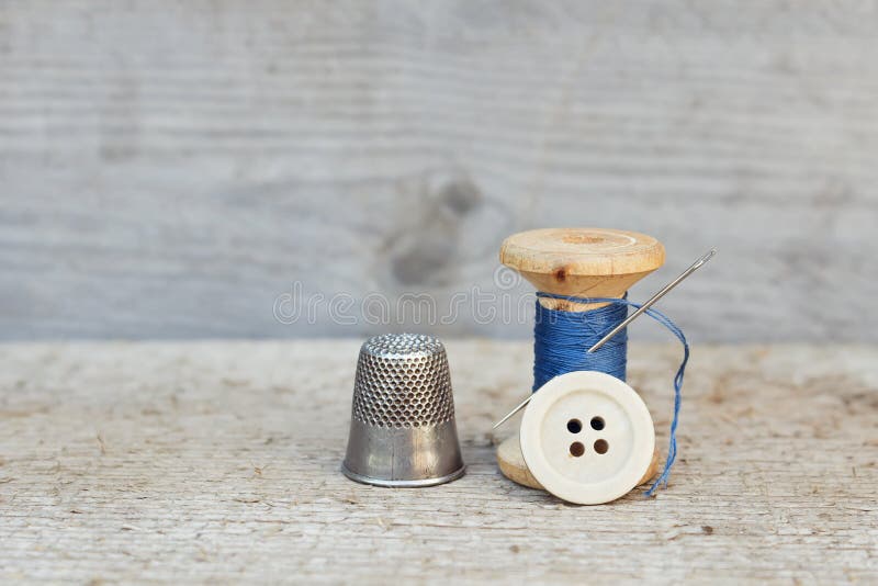 Vintage Reel of Thread, Button and Needle Stock Photo - Image of tool ...