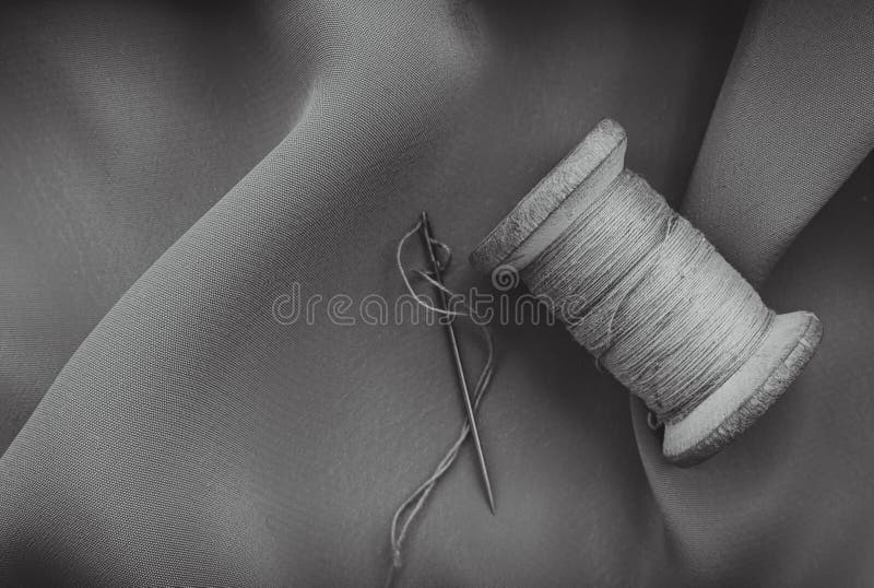 Vintage Retro Spool of Thread on a Black and White Fabric Background ...