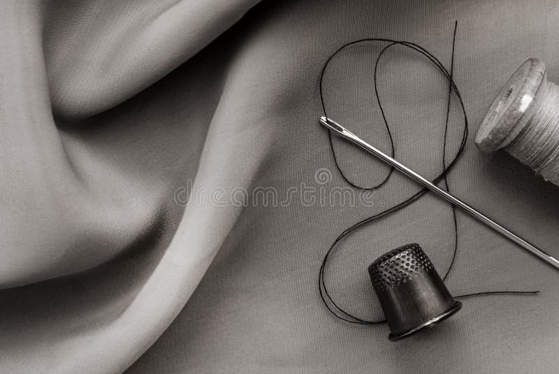 Vintage Retro Spool of Thread on a Black and White Fabric Background ...