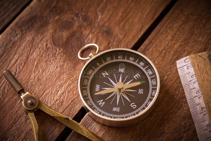 Vintage Rule, Drawing and Navigational Compass on a Rustic Wooden Board ...
