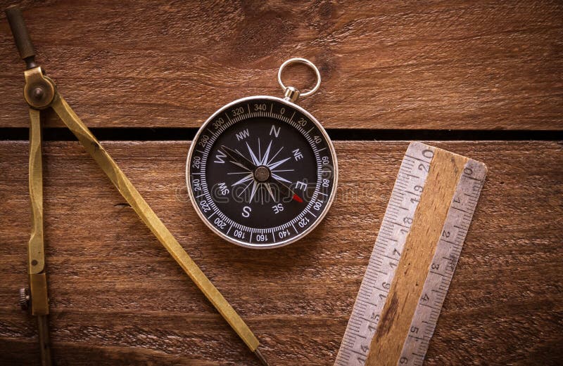 Vintage Rule, Drawing and Navigational Compass on a Rustic Wooden Board ...