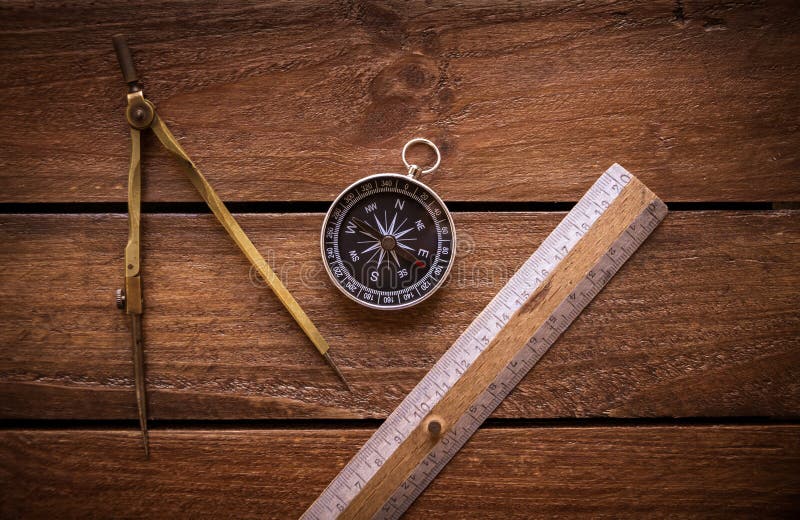 Vintage Rule, Drawing and Navigational Compass on a Rustic Wooden Board ...