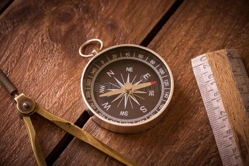 Vintage Rule, Drawing and Navigational Compass on a Rustic Wooden Board ...
