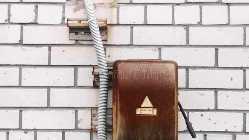 An Old, Rusty Electric Inlet Panel with a Wire in a Plastic Protection ...