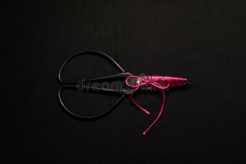 Vintage Scissors Wrapped with Bright Pink Thread on a Dark Background ...