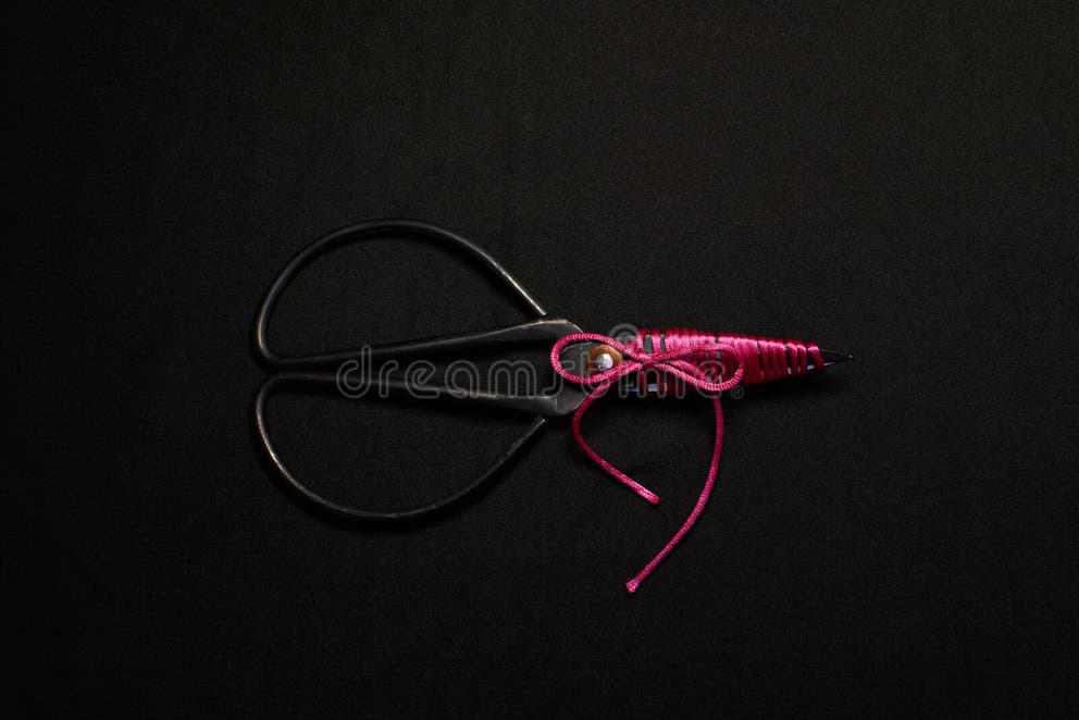 Vintage Scissors Wrapped with Bright Pink Thread on a Dark Background ...