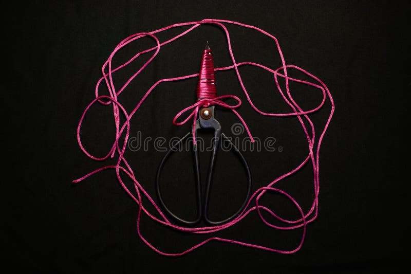 Vintage Scissors Wrapped with Bright Pink Thread on a Dark Background ...