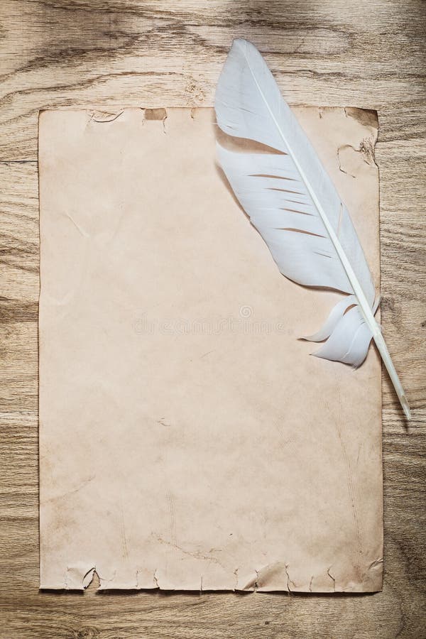 Vintage Sheet of Paper Feather on Wooden Board Stock Image - Image of ...