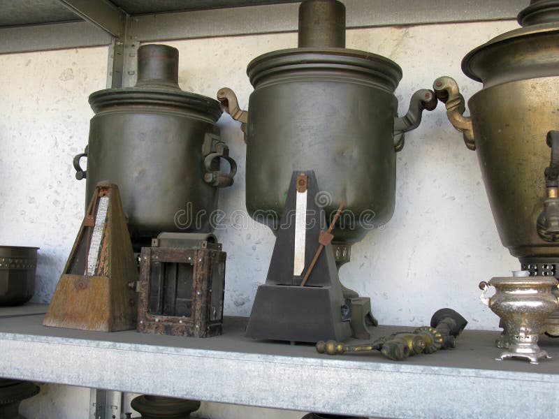 Vintage Shelf Display of Samovars, Metronome, and Antique Tools in a ...