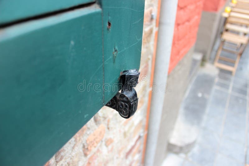 Vintage Shutters on Very Old Windows, with a Metal Figurine Lock Stock ...
