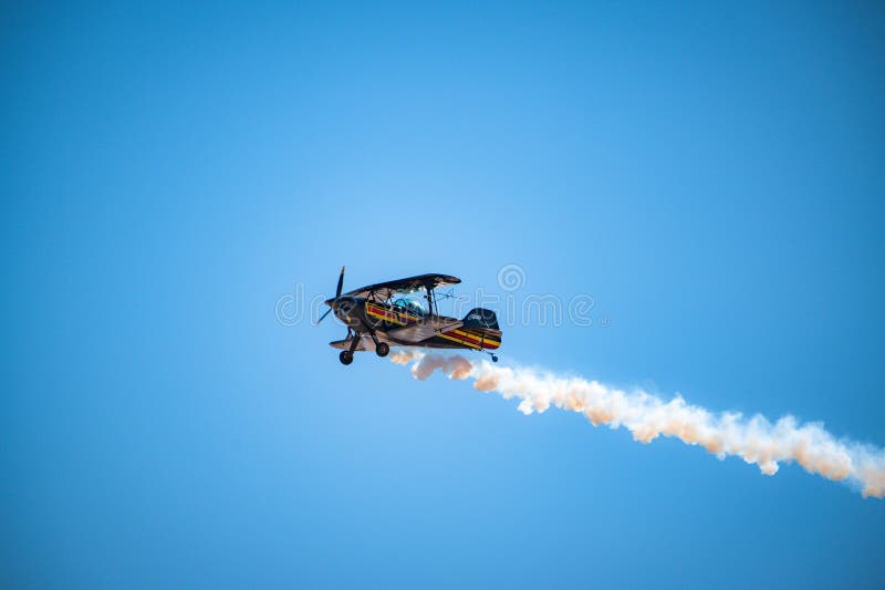 Vintage Single-engine Plane Soaring through the Sky, with a Long Trail ...