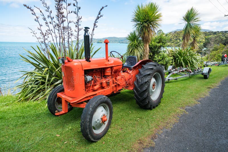 Vintage Small Red Tractor by the Lake Stock Photo - Image of earth ...