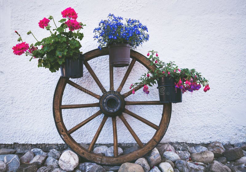 Vintage Style Image of Flower Pot with Wooden Wheel Stock Photo - Image ...