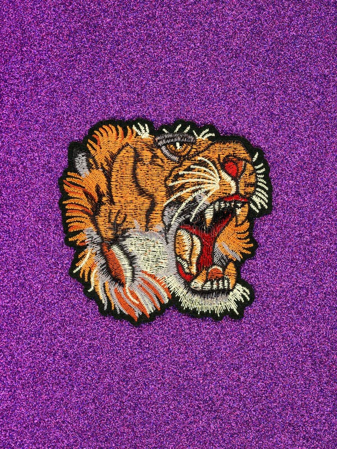 A Vintage Tiger Patch on a Glitter Ultra Violet Background Stock Image ...