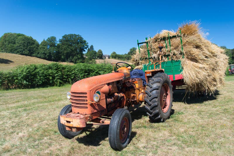 Vintage tractor with hay stock photo. Image of retro - 78007802
