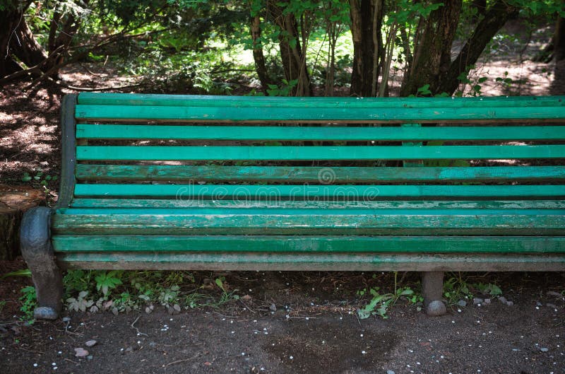Vintage Weathered Bench with Chipped Paint Sits in Quiet Shade Stock ...