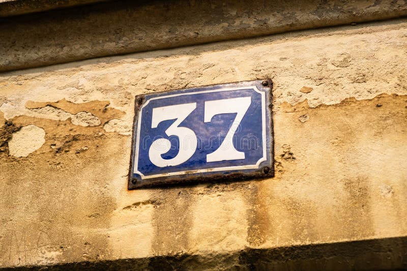 Vintage Weathered House Number 37 Plaque on Rustic Wall Stock Photo ...