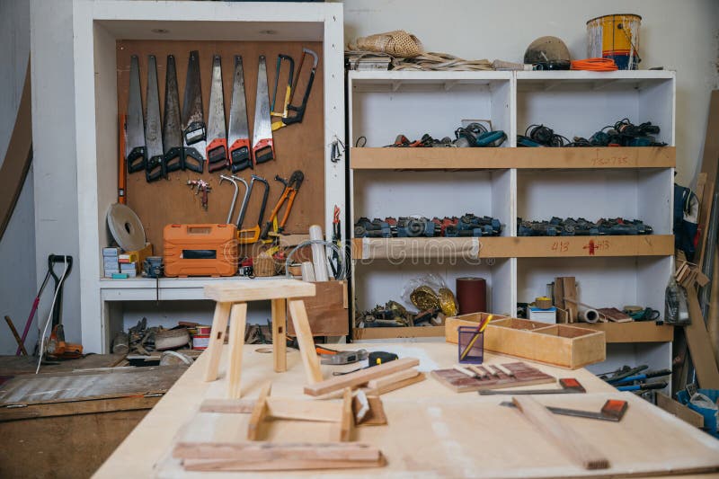 Vintage Wooden Workbench in a Cluttered Workshop with Various Tools and ...