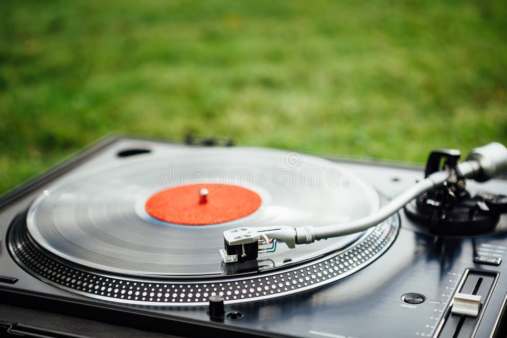 Vinyl Disc Playing on Turntable, Green Grass Background Stock Photo ...