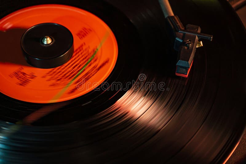 Vinyl Record Spinning on Turntable with Red Label and Needle Playing ...